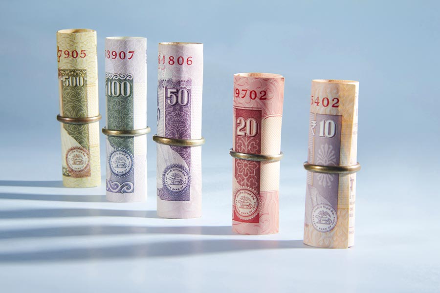 Variation of Indian Rupee banknotes roll with ring Money Concept