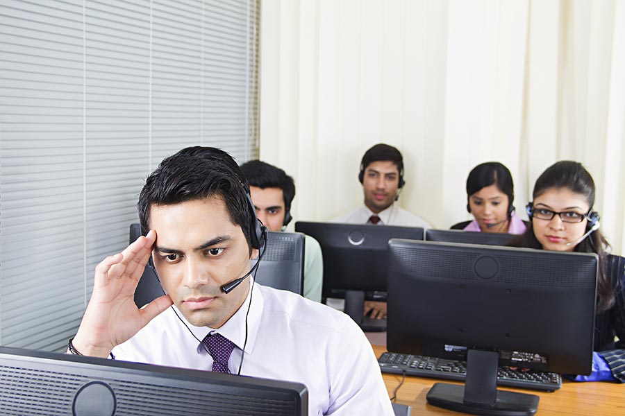 Sad Indain male Customer Service Agent In Call Center Badnews