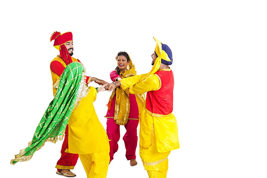Two Punjabi couples in-traditional clothing playing Kikli game on ...
