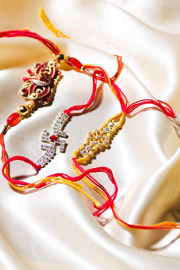 Indian festival raksha bandhan Rakhi on-silk cothes on-background