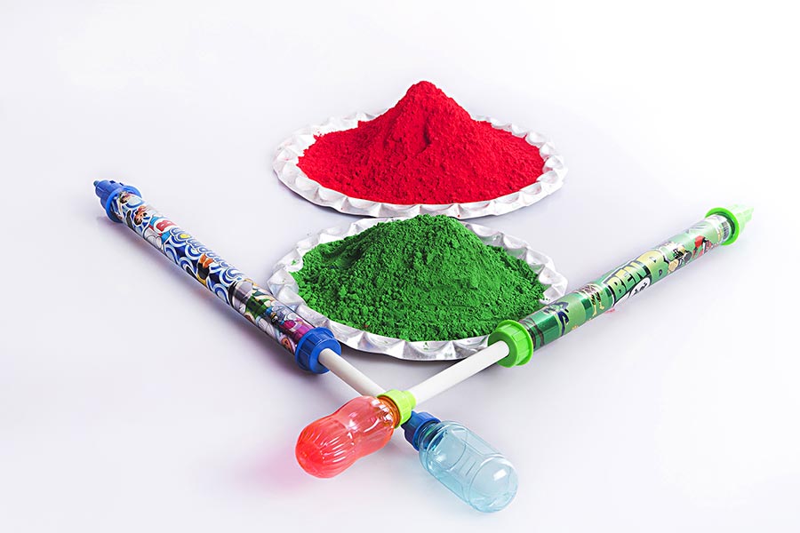 Closeup-of Red Gulal Color Powder In-Plate With Pichkari on-holi festival