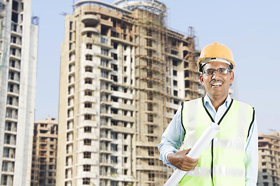 Indian Senior Architect Man Holding Blueprint Standing In Construction ...