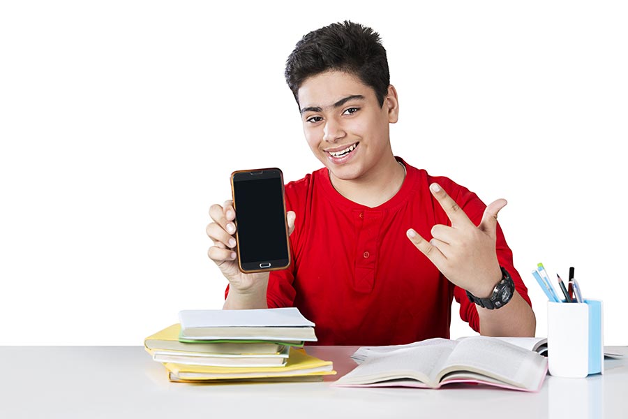 Young College Boy Student With Book Showing Cell-Phone And hand Gesturing
