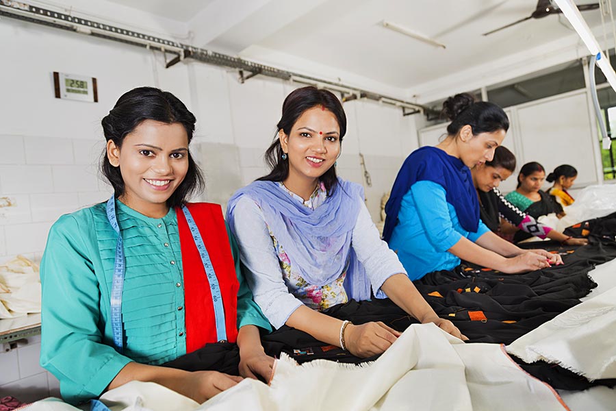 Group-of Female Clothing Factory Workers Working together in-Clothing ...